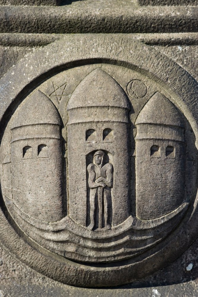 Three Towers Symbol Carved in a Stone Column in the City Hall Square
