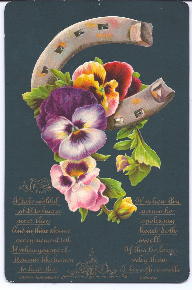 A Victorian good luck greeting card of a horseshoe and pansies, circa 1880