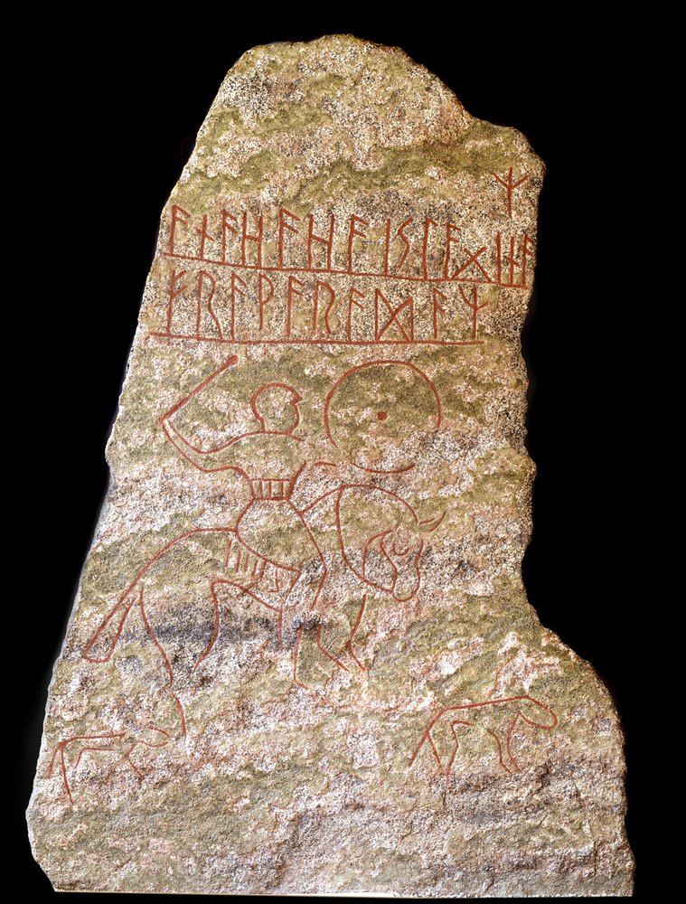 A Stele with Runic Inscriptions Representing a Viking Horseman with a Dog