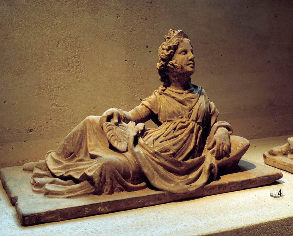 Etruscan art: funeral urn cover depicting the deceased's wife holding a ...