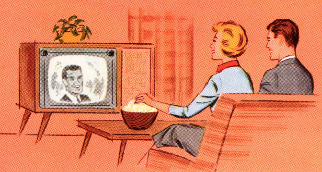Couple Watching a Retro Television in Their Den