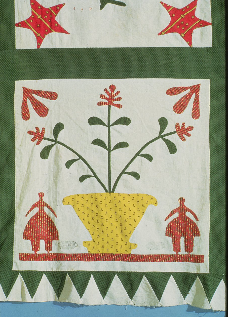 Quilt (detail) showing figures and flowers