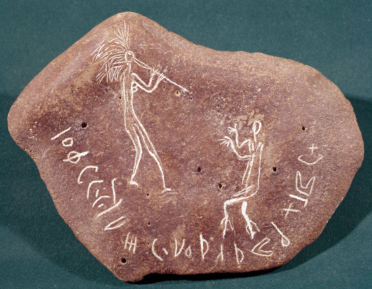 Stone inscribed with a dancer, flute player and a safaitic inscription