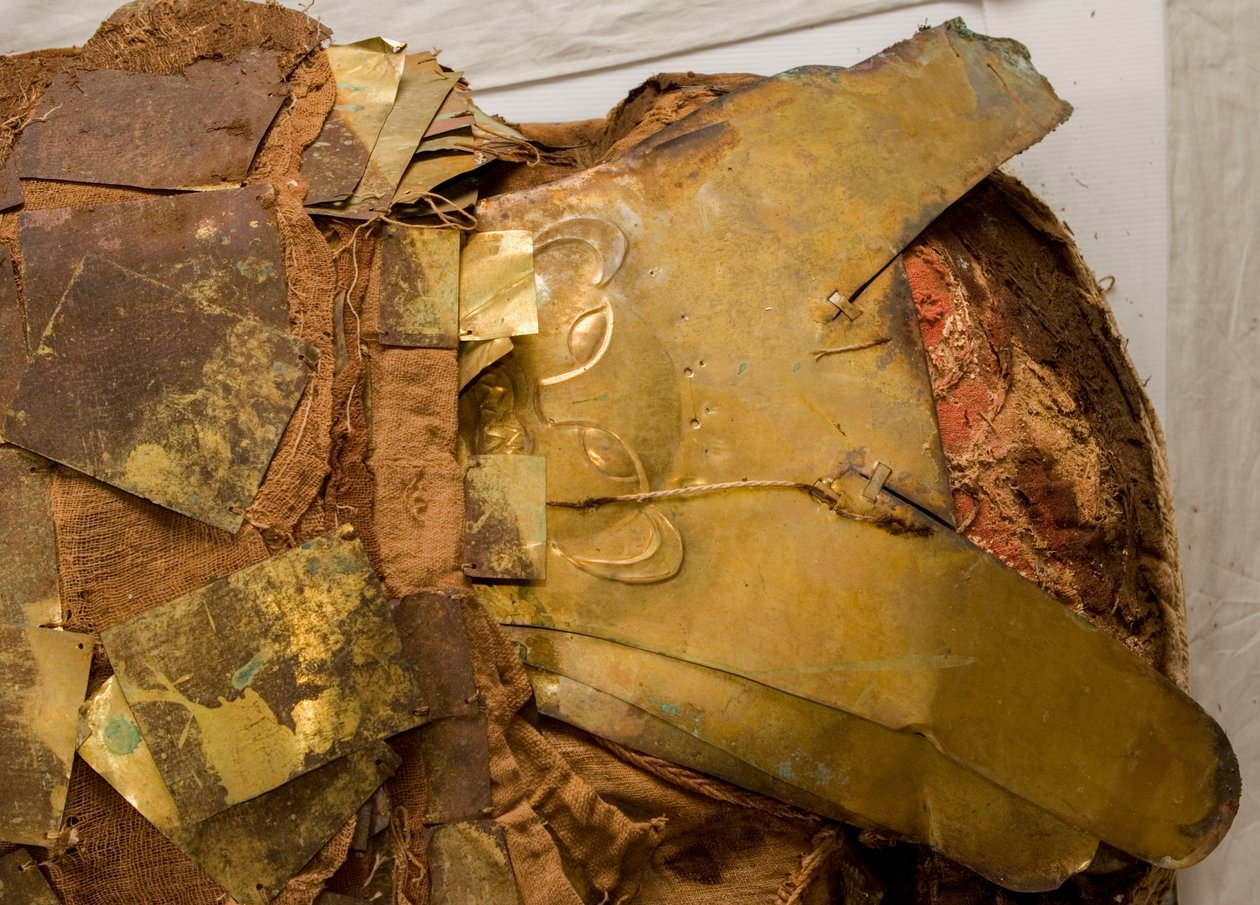 A golden mask with a monkey image revealed by Ira Block