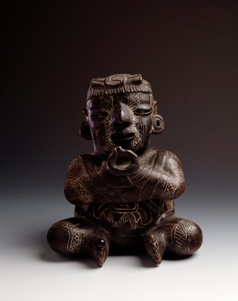 Anthropomorphic clay vase depicting a man seated with hands joined in ...