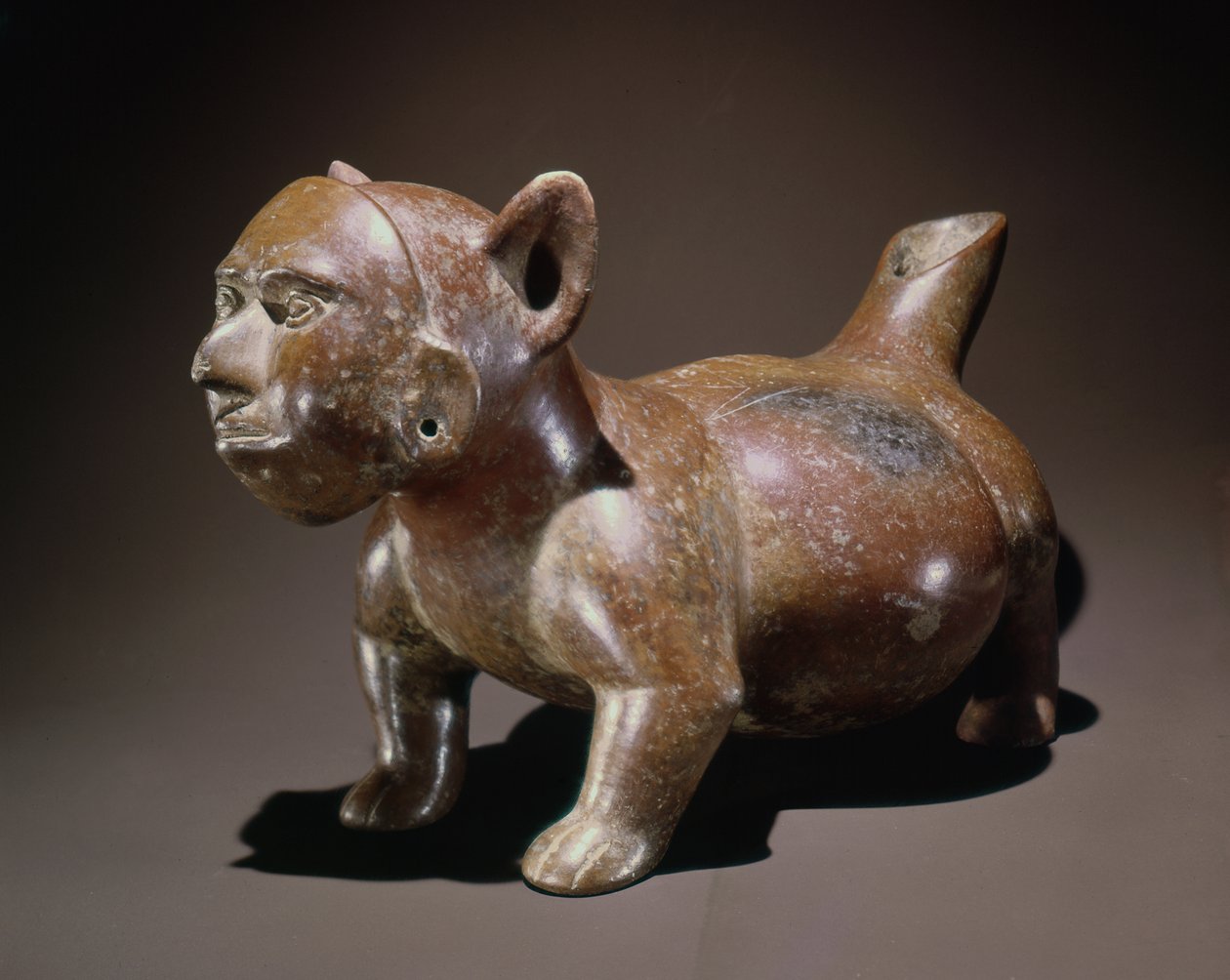 Effigy vessel representing a dog wearing a mask in the form of a human ...