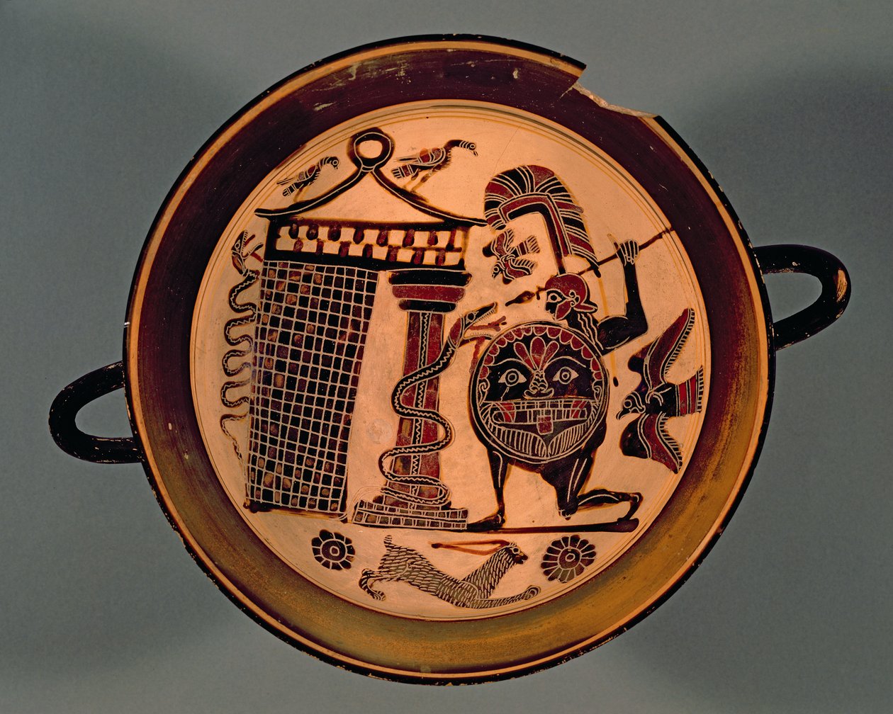 Laconian black-figure cup depicting a warrior attacking a snake